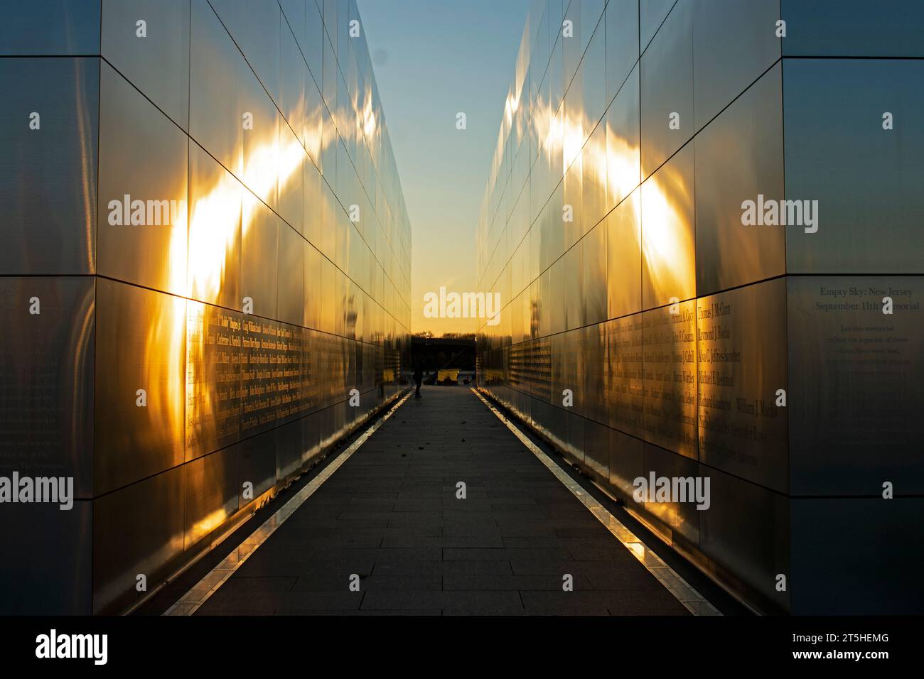 The setting sun reflects a ring of fire inside the Empty Sky memorial ... The setting sun reflects a ring of fire inside the Empty Sky memorial ...