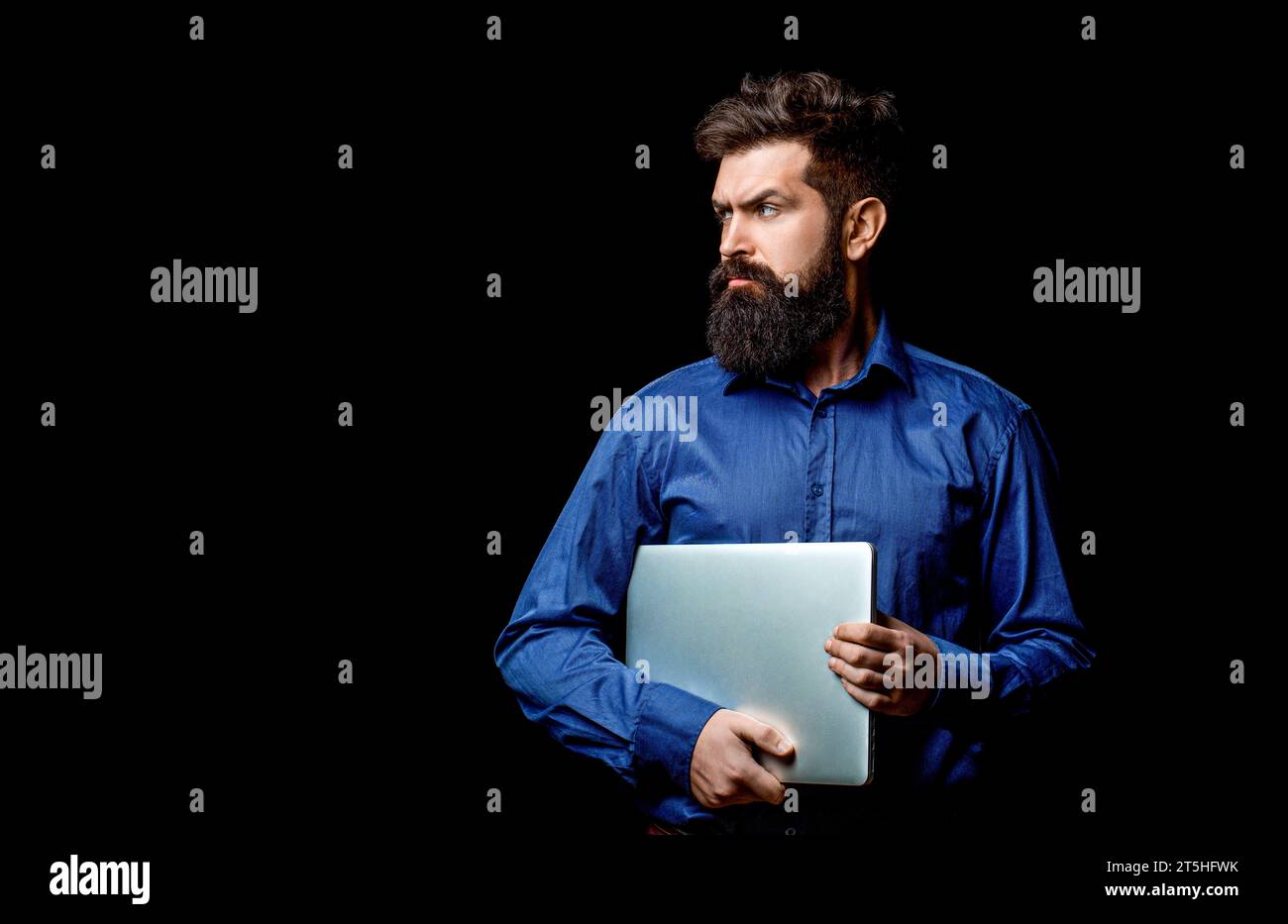 Holding laptop computer. Serious handsome bearded man worker laptop ...