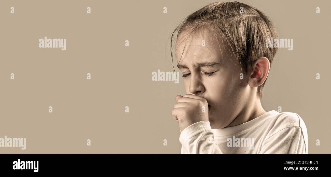 Treatment of colds and flu. Boy coughing sick colds sneezing cough. Children coughs. Child is ...