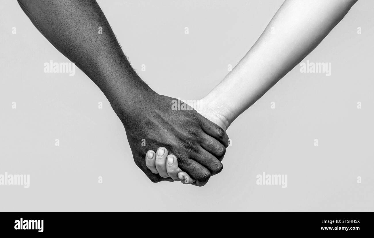 African peace symbol. Woman and man holding hands together. White woman ...