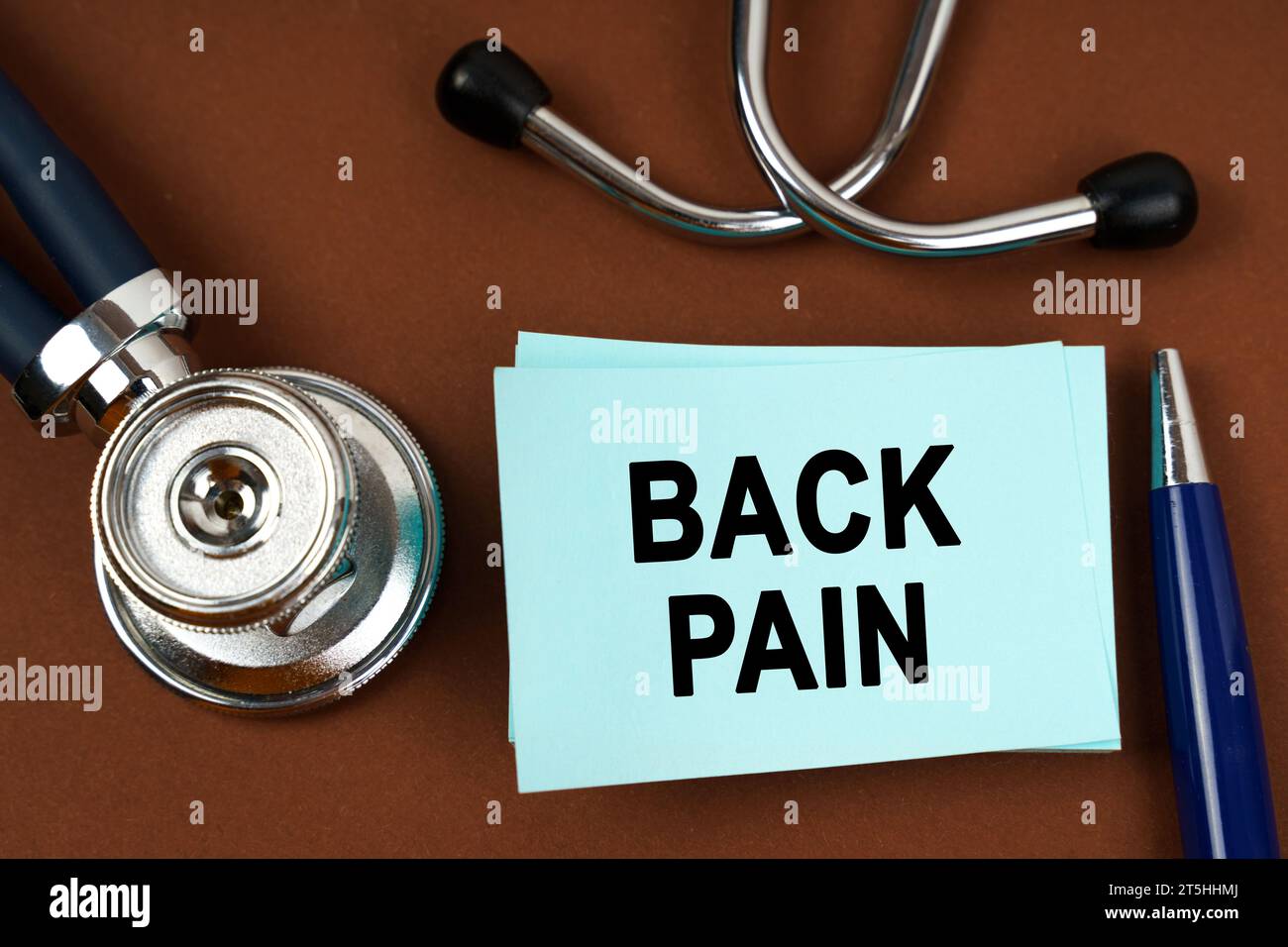 Medical concept. On a brown surface there is a stethoscope, a pen and ...