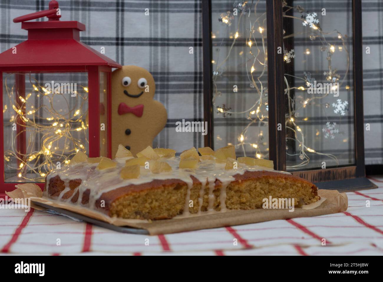 Gingerbread man looking excitedly at an iced cake at Christmas time ...
