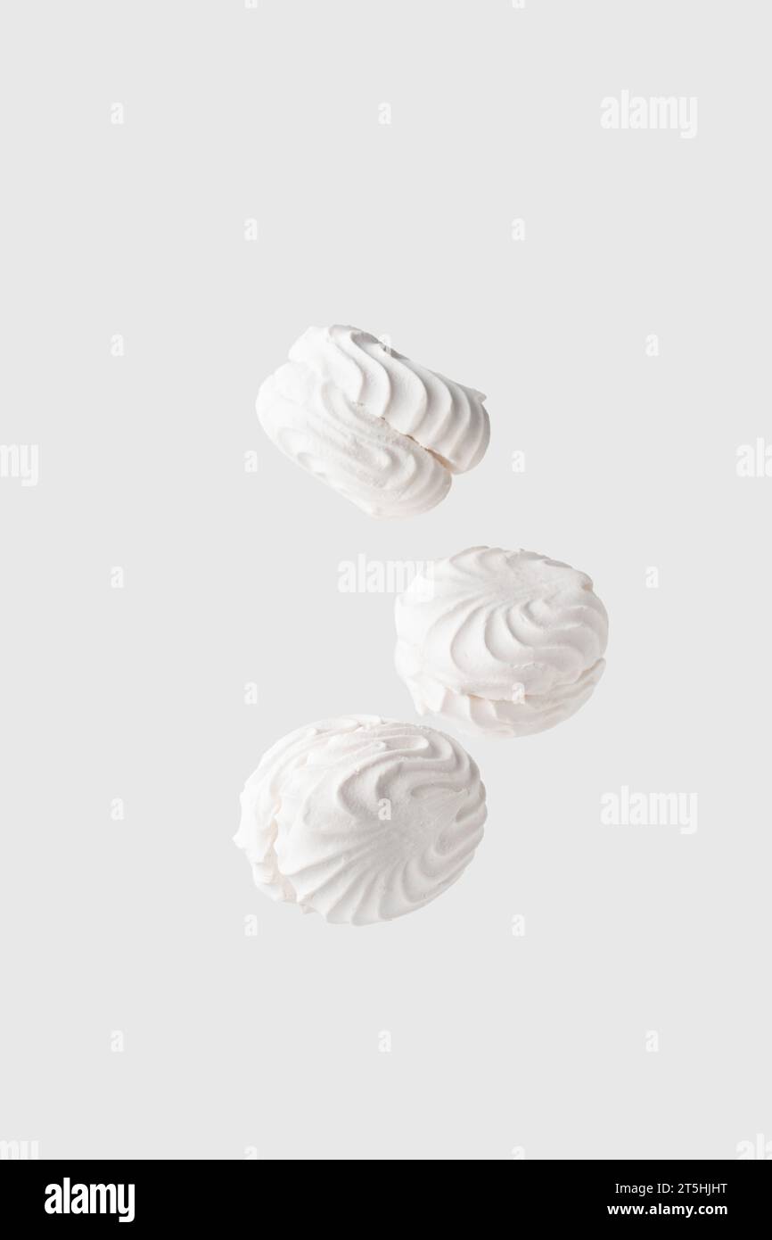 Soaring white zephyr marshmallow on white background. flying food ...