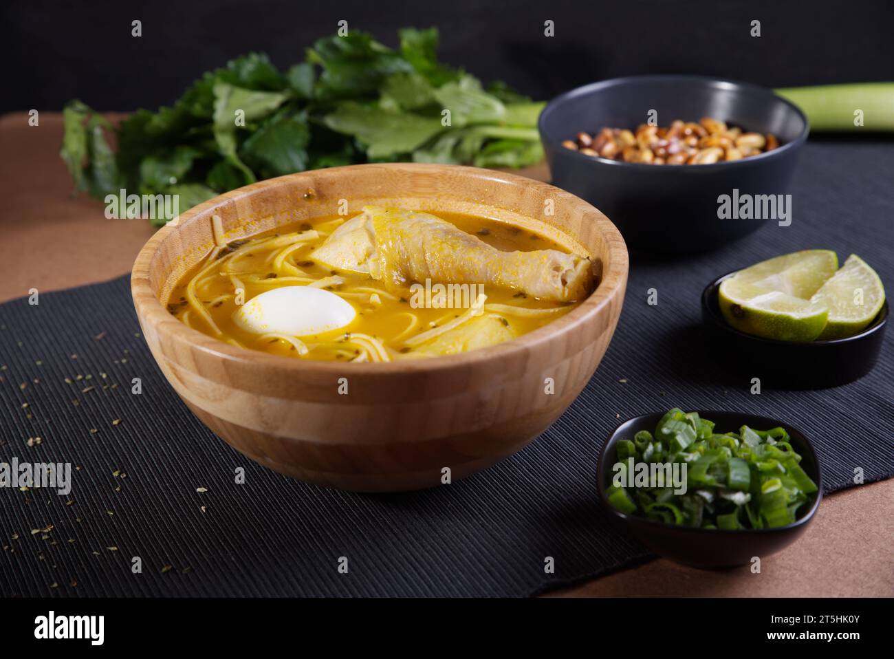 Typical Peruvian dish known as chicken soup, in a wooden bowl with ...