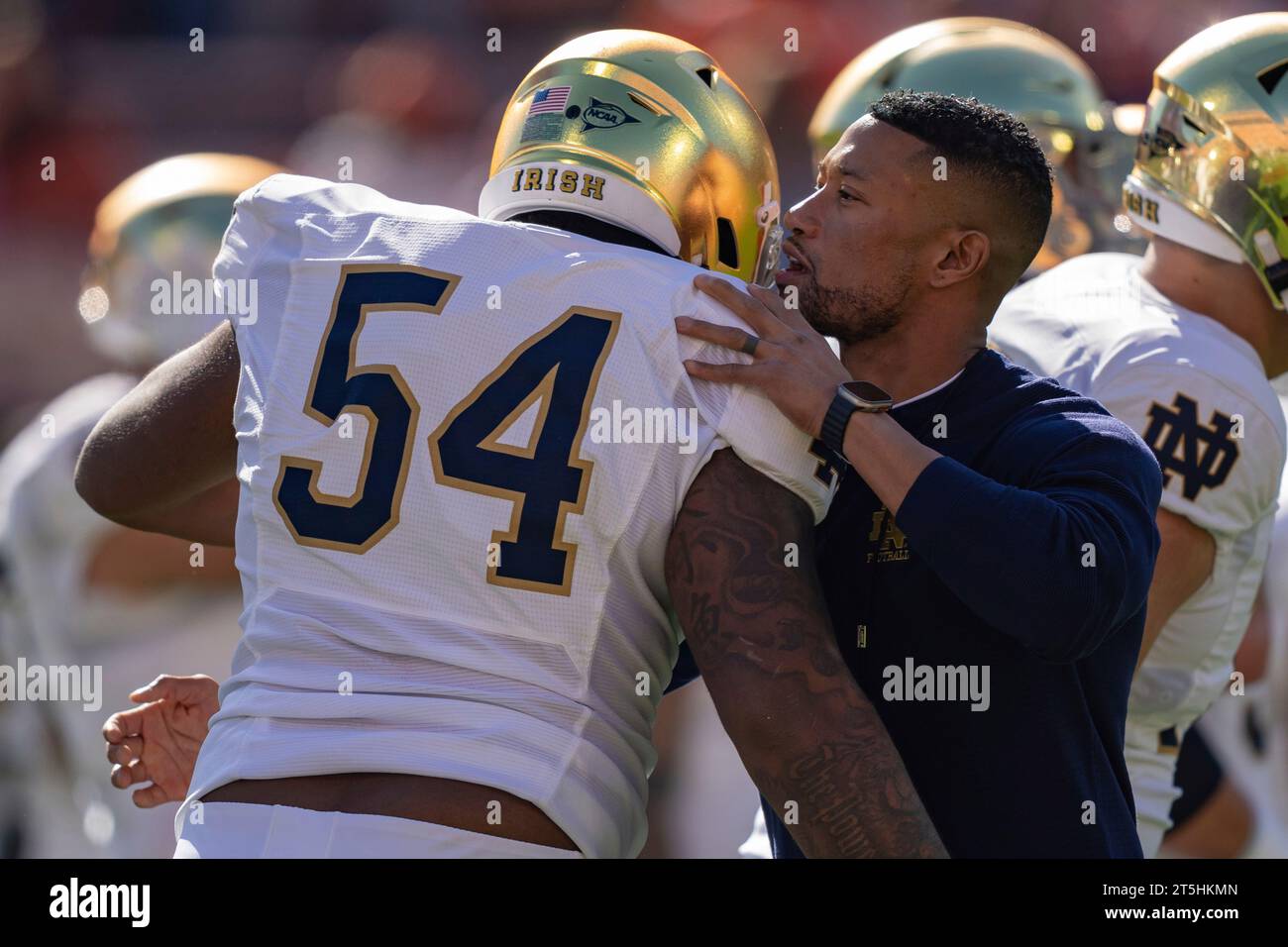 Notre Dame head coach Marcus Freeman talks with offensive lineman Blake ...