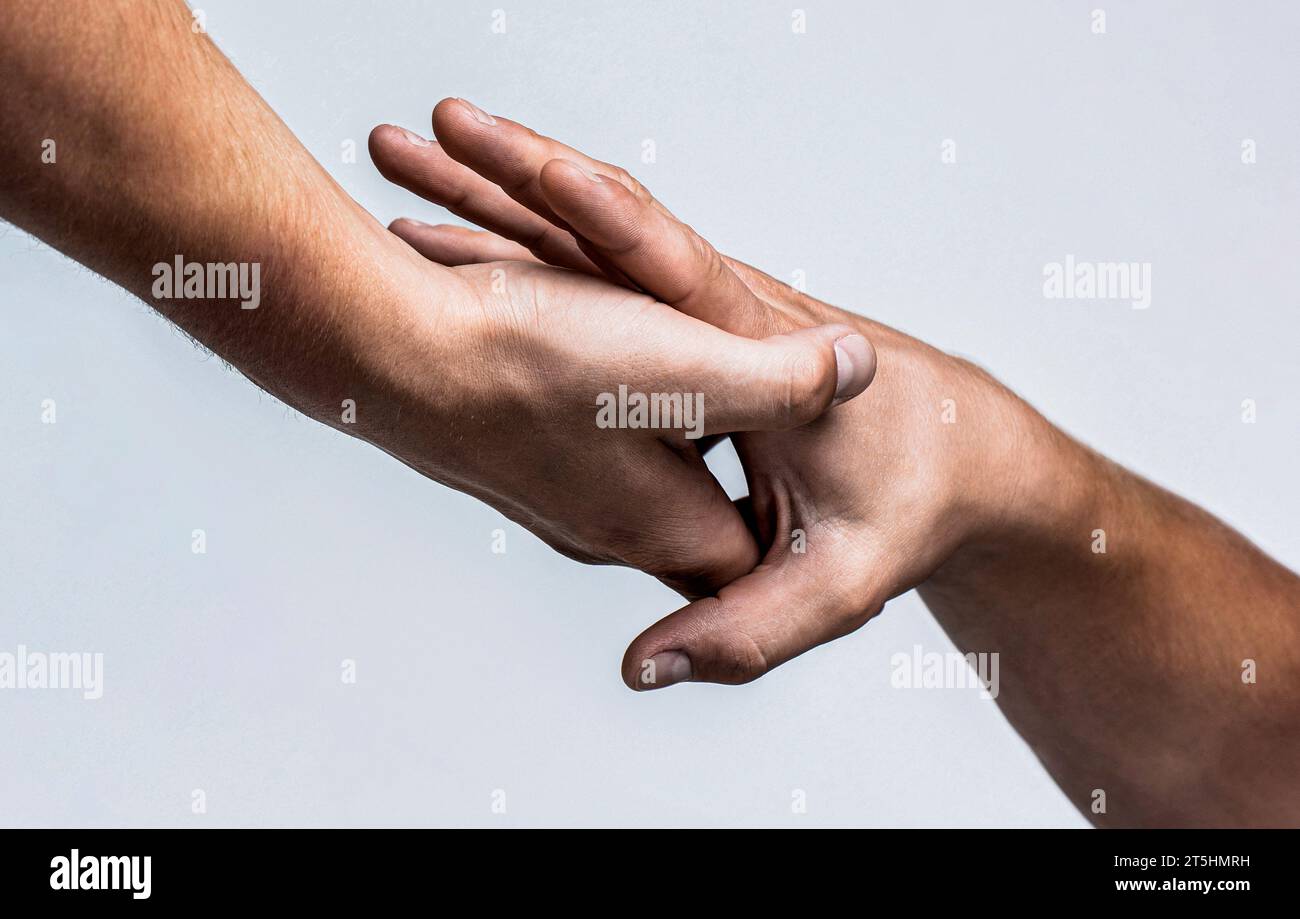 Two hands, helping arm of a friend, teamwork. Rescue, helping gesture or hands. Close up help ...