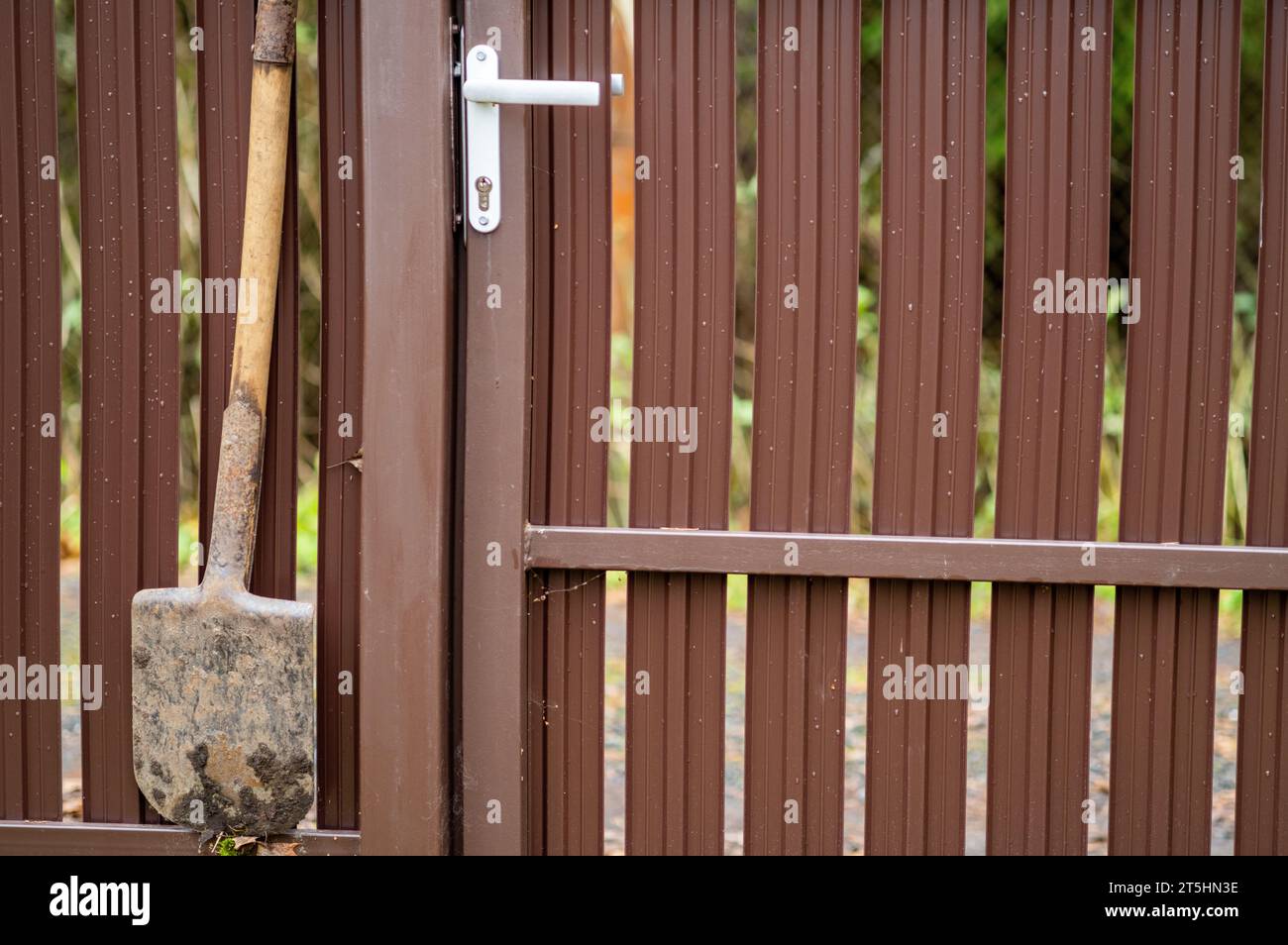spade behind fence Stock Photo - Alamy