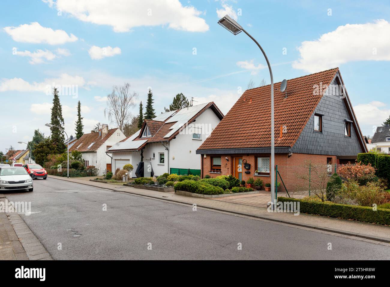 City street of single-family modern houses Germany against blue sky ...