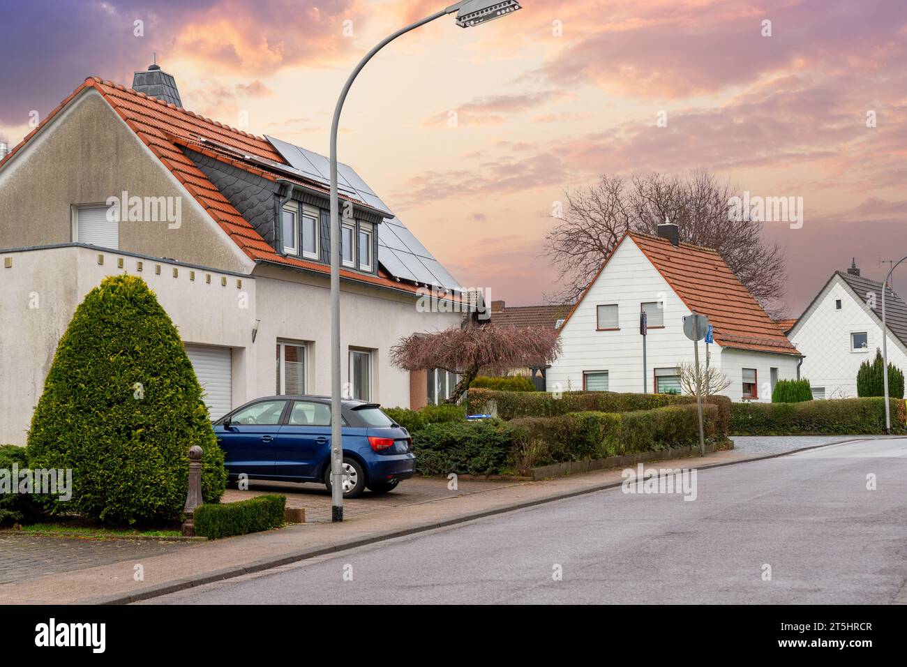 City street single-family modern houses Germany against warm sunset sky ...