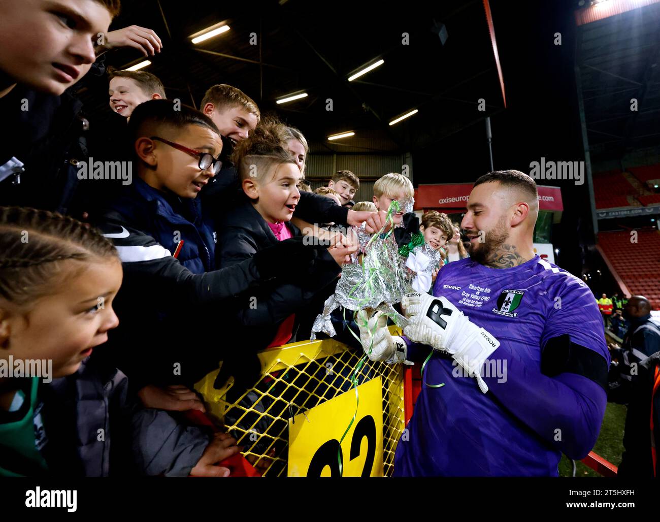 Cray Valley goalkeeper Sam Freeman is handed a replica of the Emirates ...