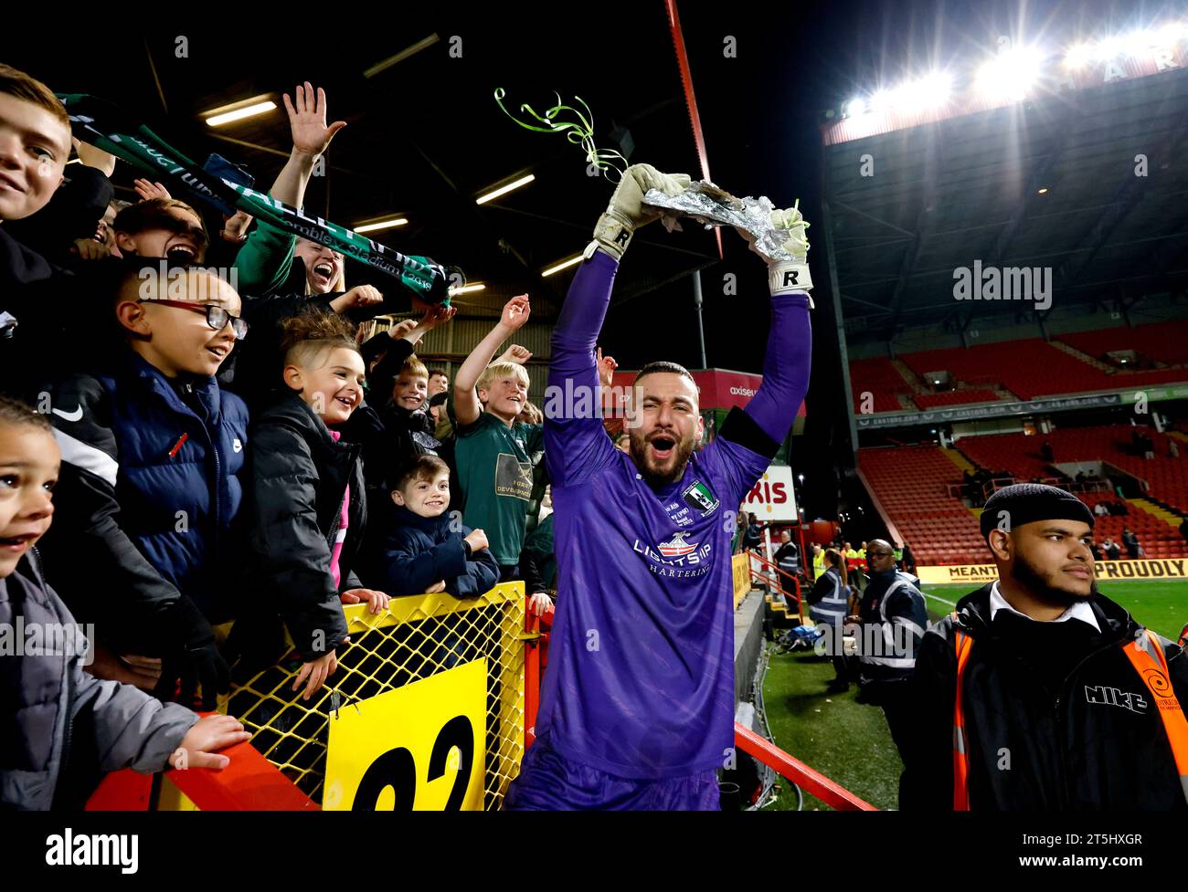 Cray Valley goalkeeper Sam Freeman celebrates with a replica of the ...
