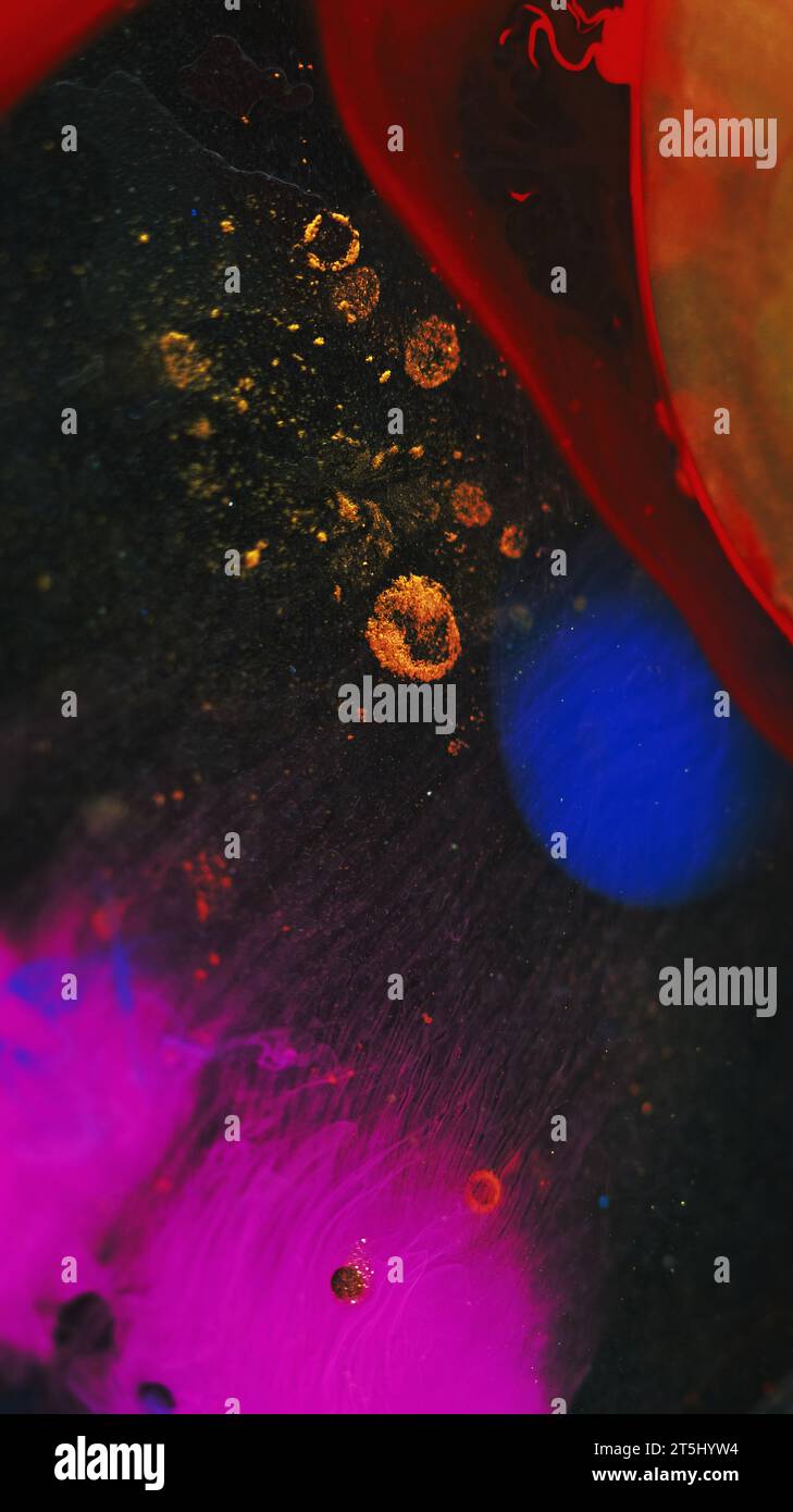 Ink water drop oil bubbles color glitter paint mix Stock Photo - Alamy