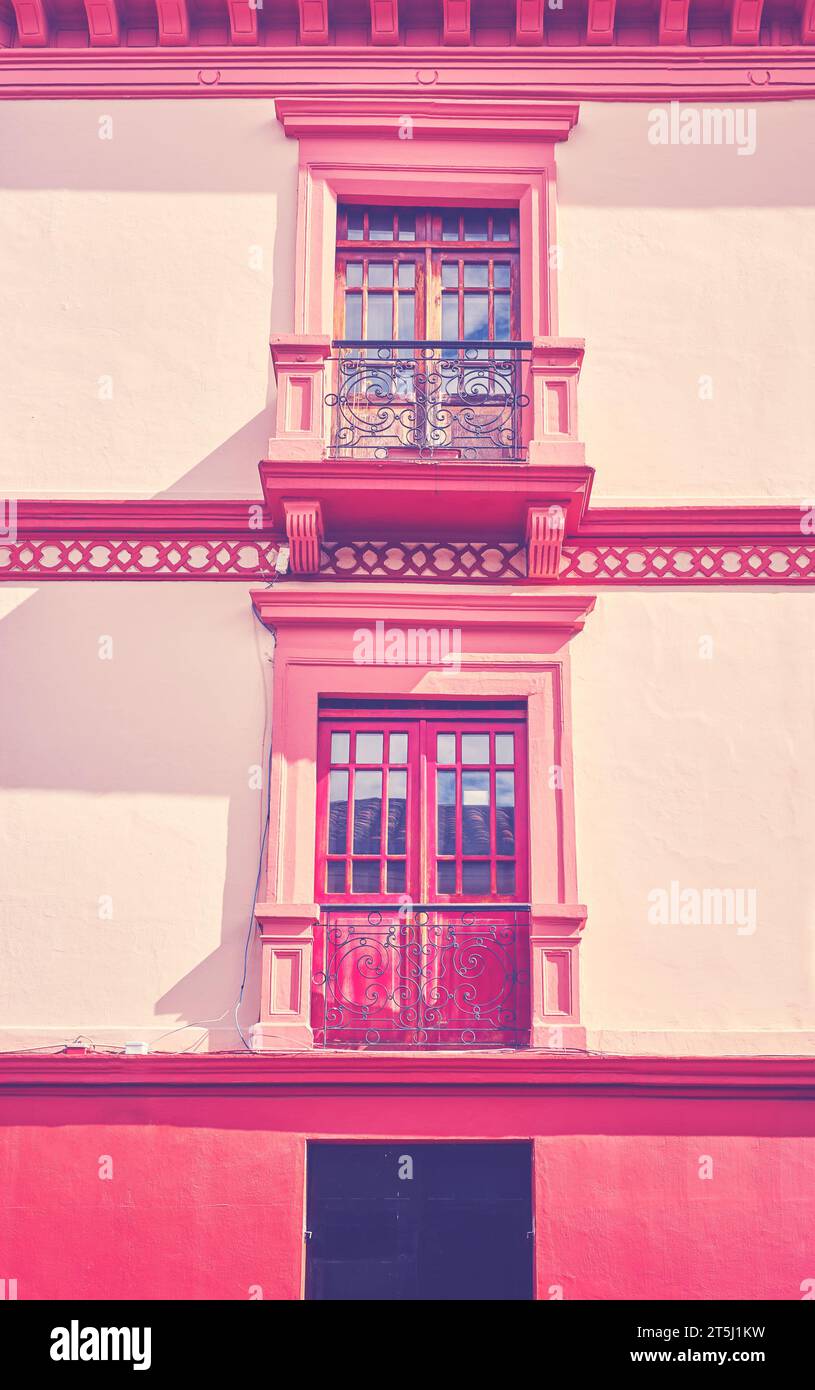 Street view of an old colonial building facade in Quito, color toning ...