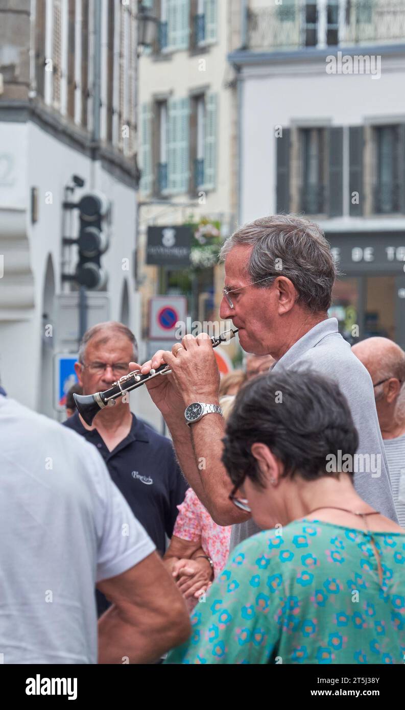 Flute player surrounded by dancing crowd on a local feast in Brittany ...