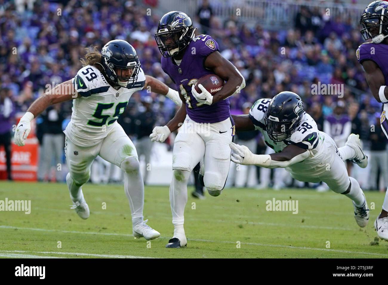 Baltimore Ravens running back Justice Hill (43) runs from Seattle ...