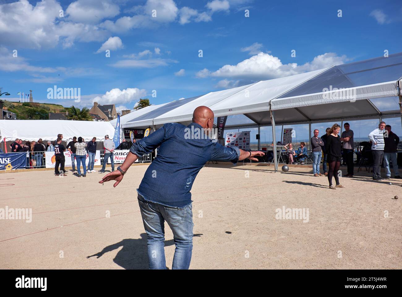 Male player throwing a ball in a boules game Stock Photo - Alamy