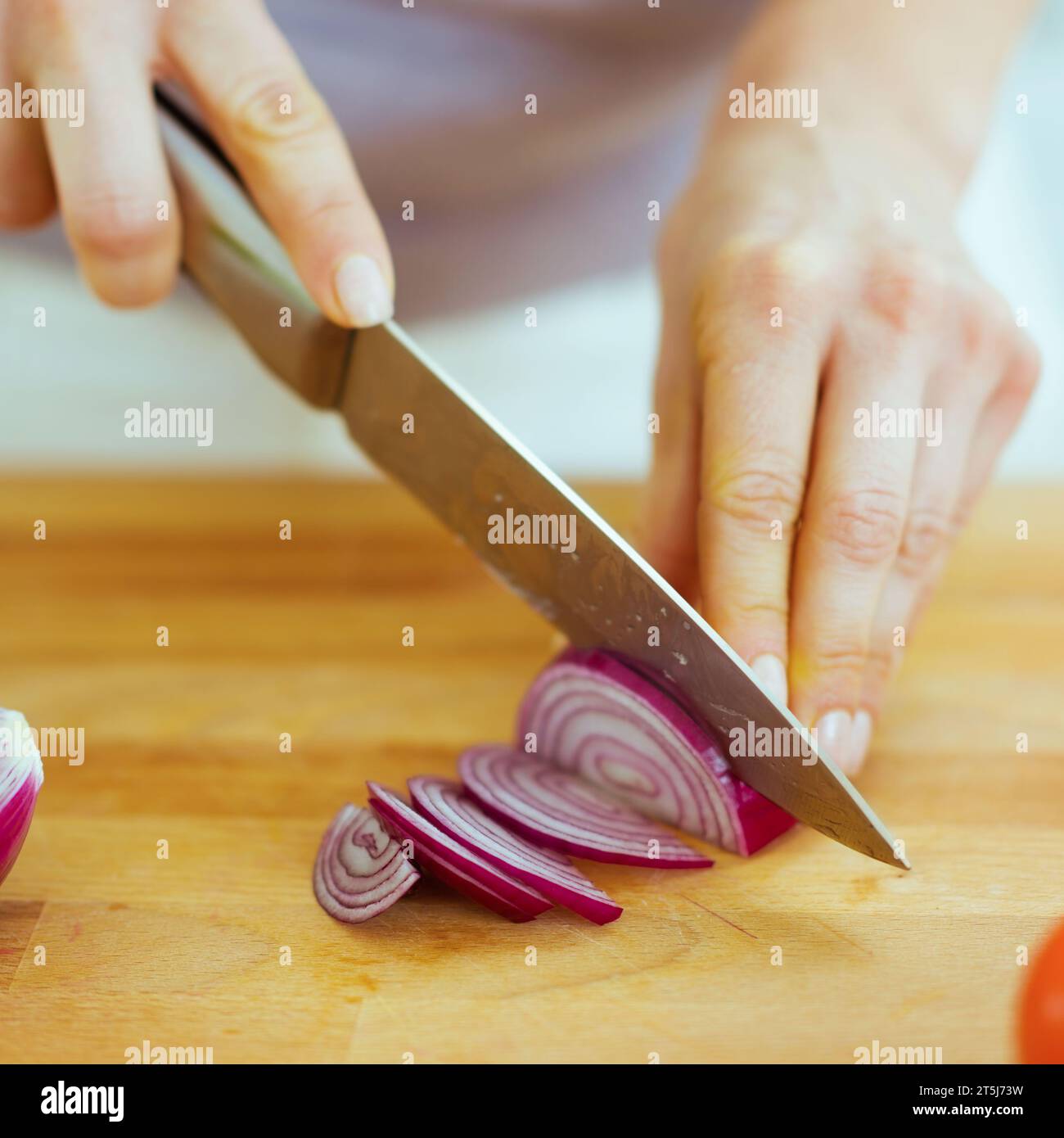 Closeup on woman cutting red onion Stock Photo - Alamy