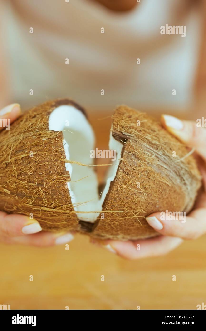Closeup on young woman opening coconut Stock Photo - Alamy
