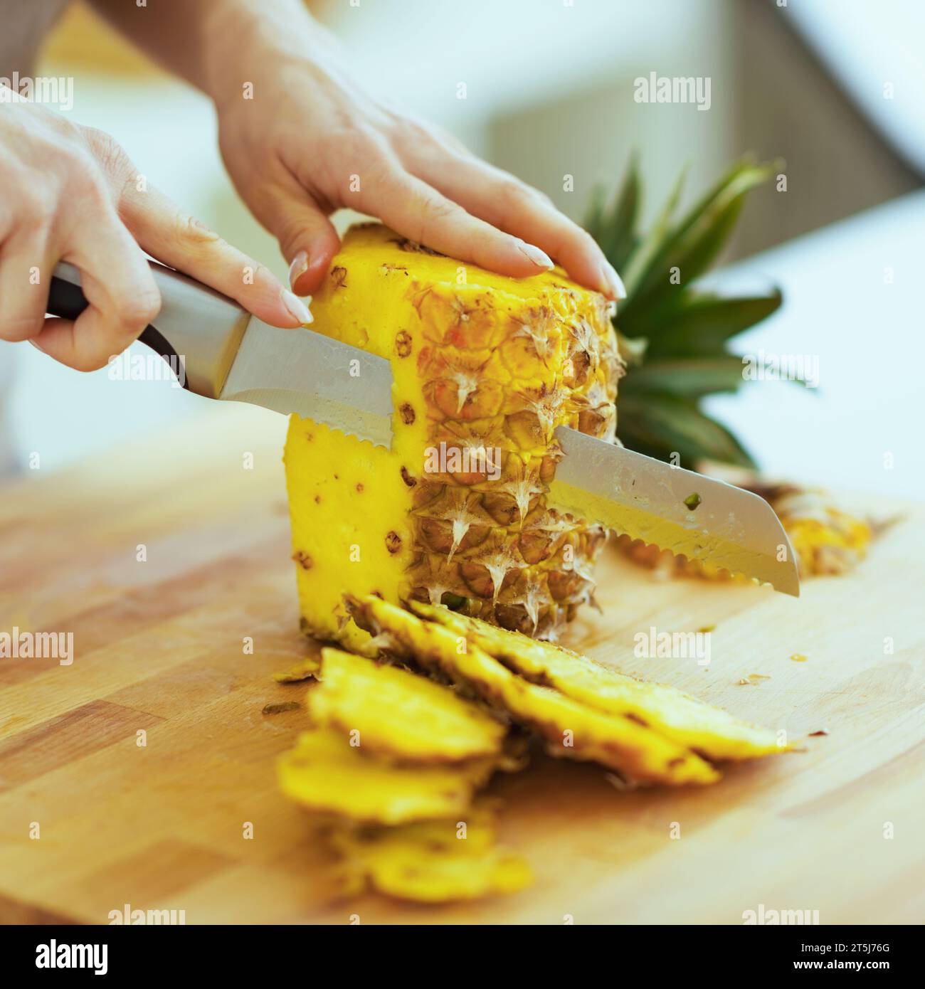 Closeup on woman cutting pineapple Stock Photo - Alamy