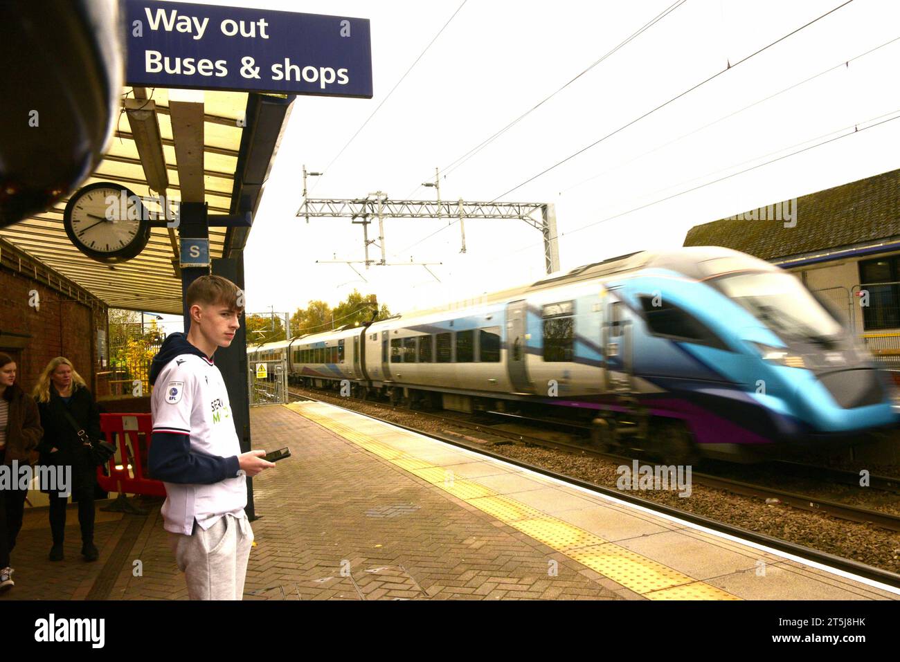 A non-stop train speeds through Chorley station, Lancashire, UK, going ...