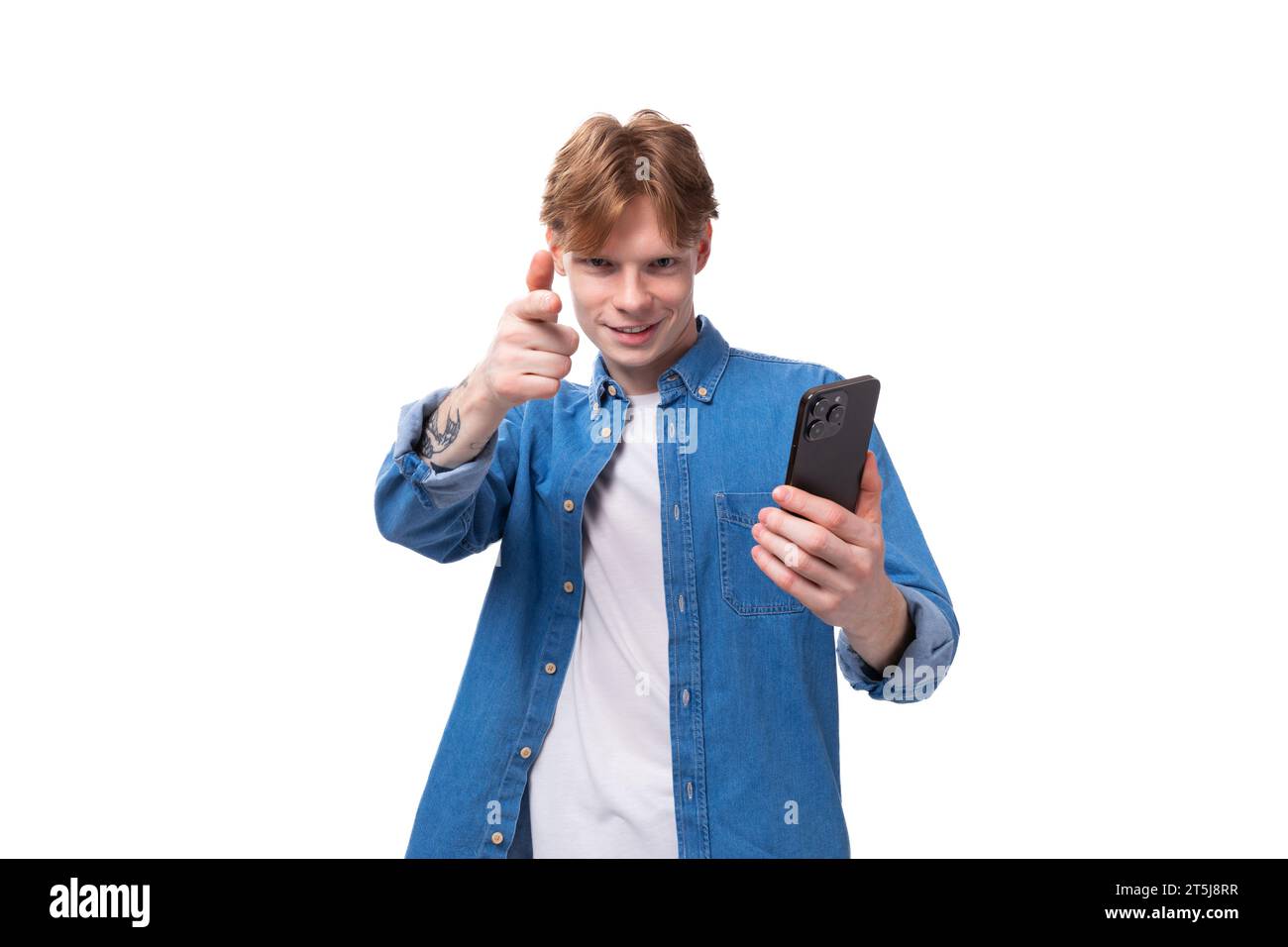 young handsome european man with copper hair dressed casually takes a ...