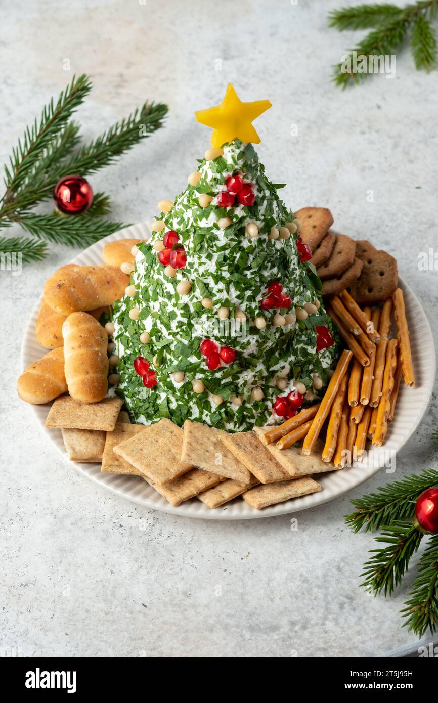 Christmas tree cheese ball appetizer with bread crackers and decorated ...