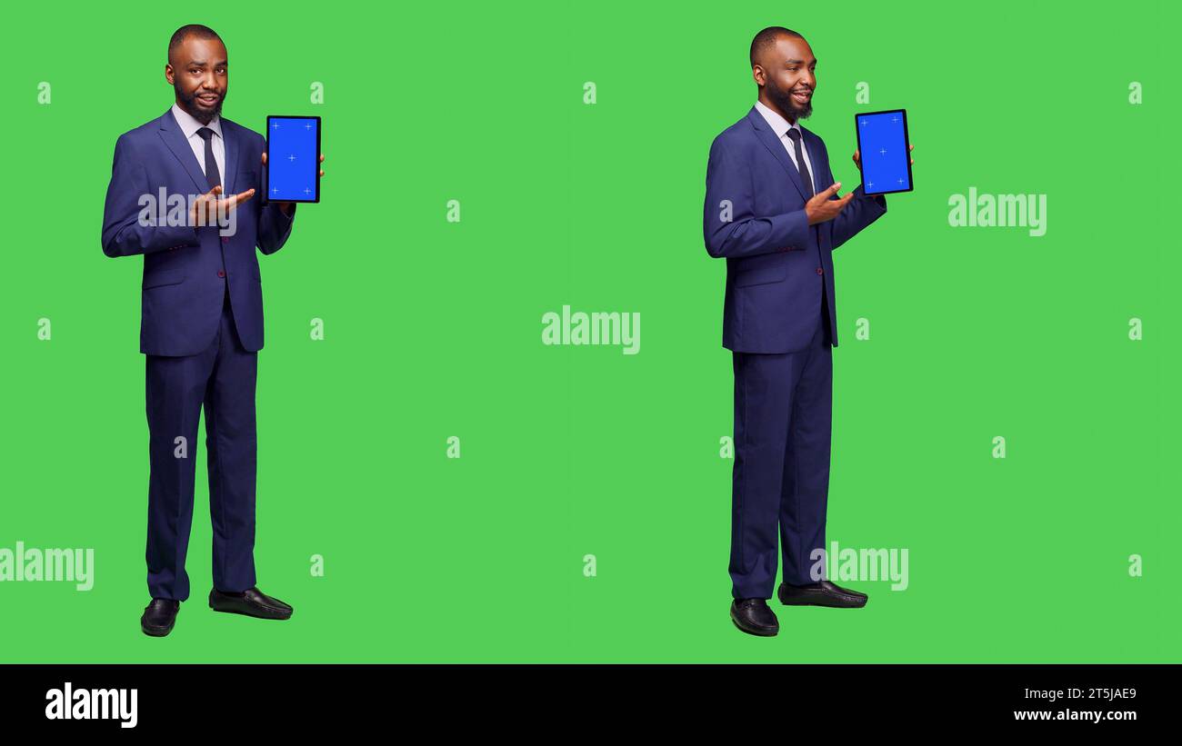 Smiling businessman showing tablet with blue screen, presenting ...