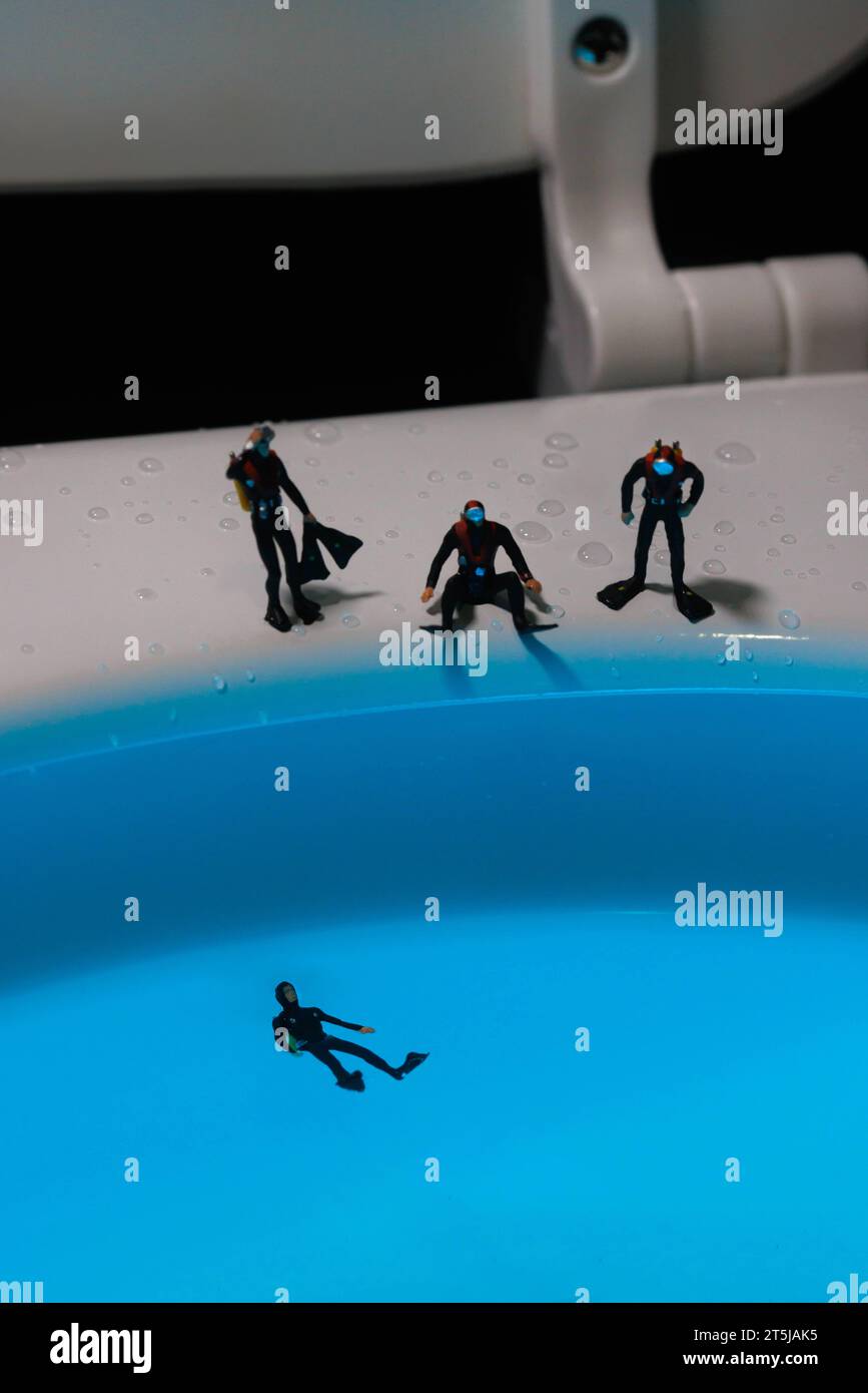 Miniature Scuba Divers in a Toilet on a Seat Stock Photo - Alamy