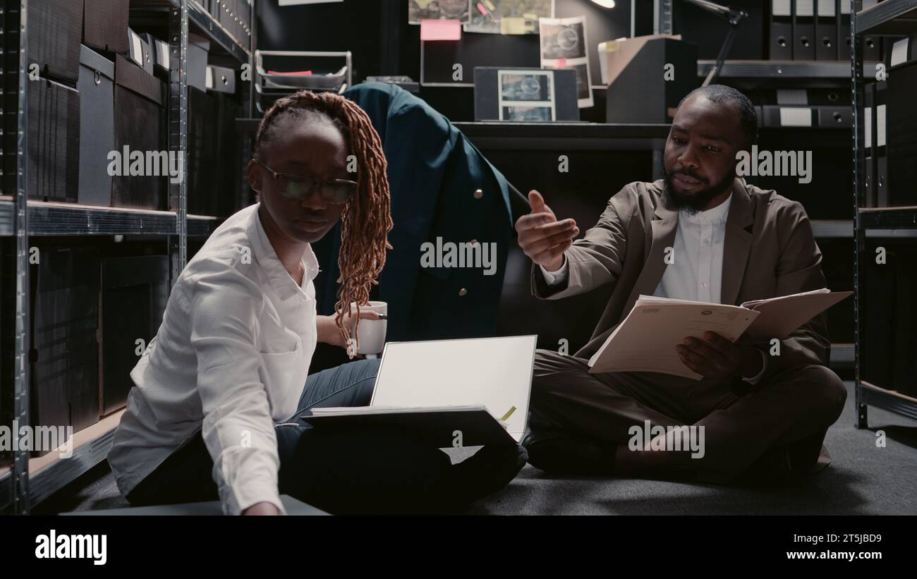 African american agents examining physical evidence to uncover new ...