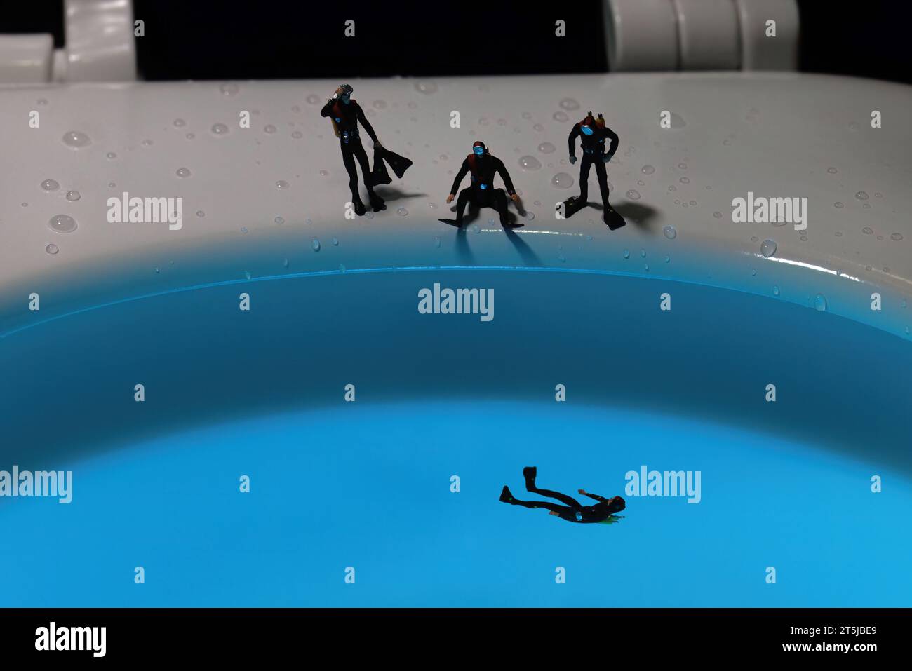Miniature Scuba Divers in a Toilet on a Seat Stock Photo - Alamy