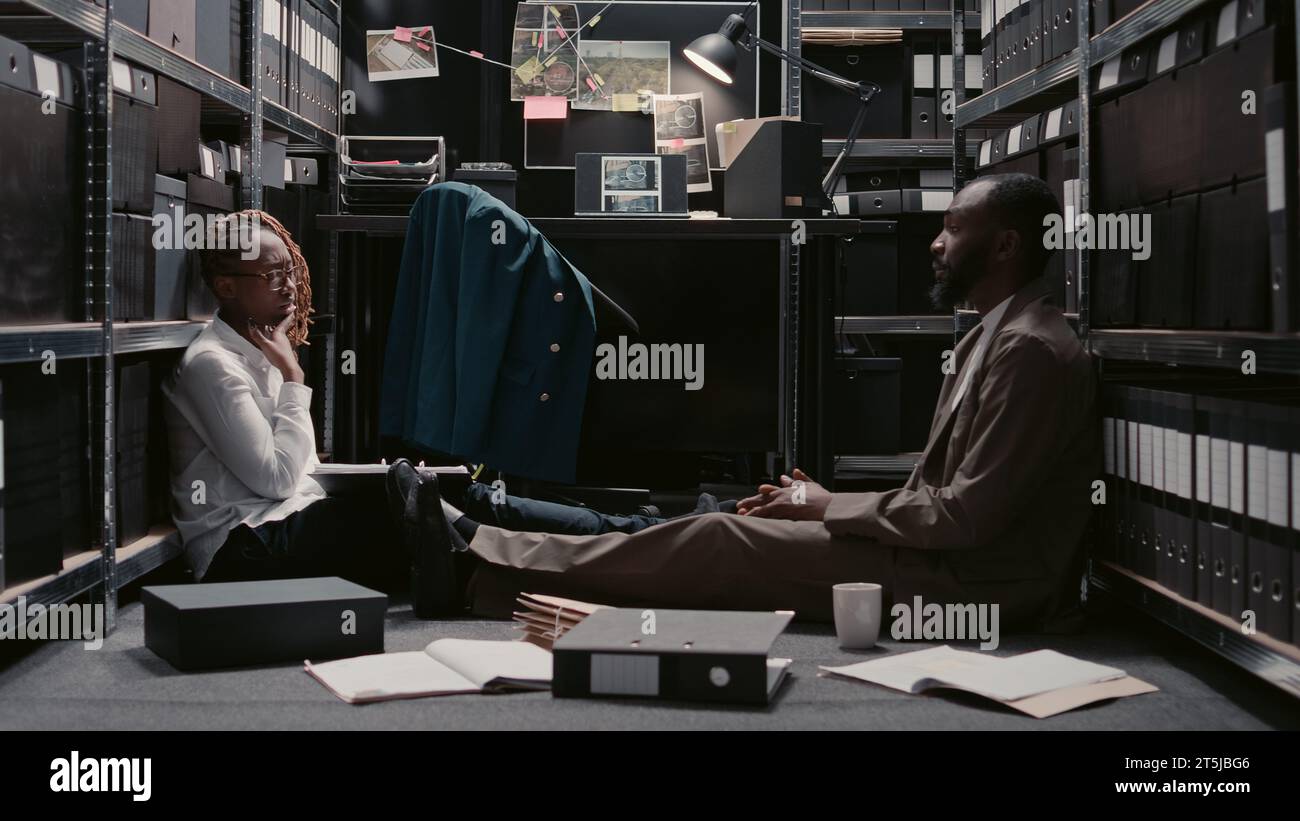 Team of detectives conducting criminal investigation in evidence room ...