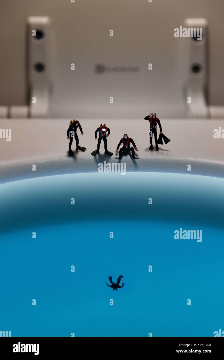 Miniature Scuba Divers in a Toilet on a Seat Stock Photo - Alamy