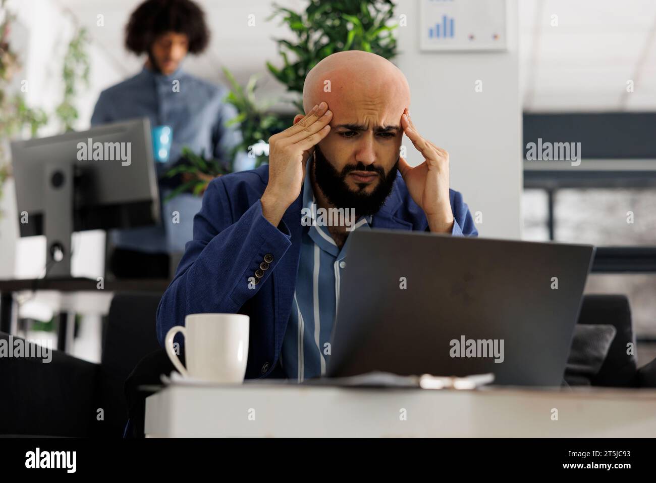 Start up product manager with headache working to meet deadlines in ...