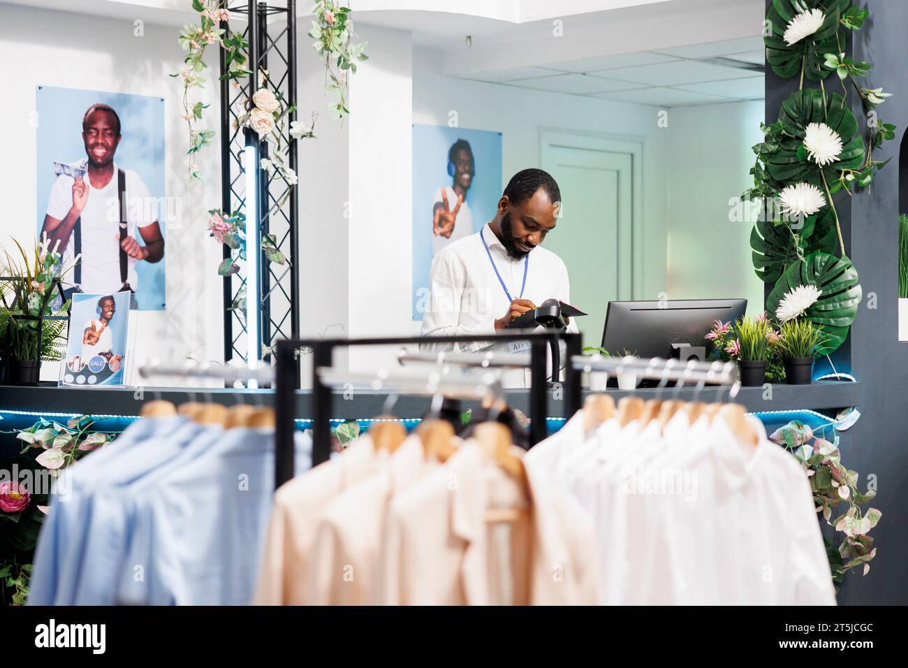 Clothing store african american employee working at counter, planning ...