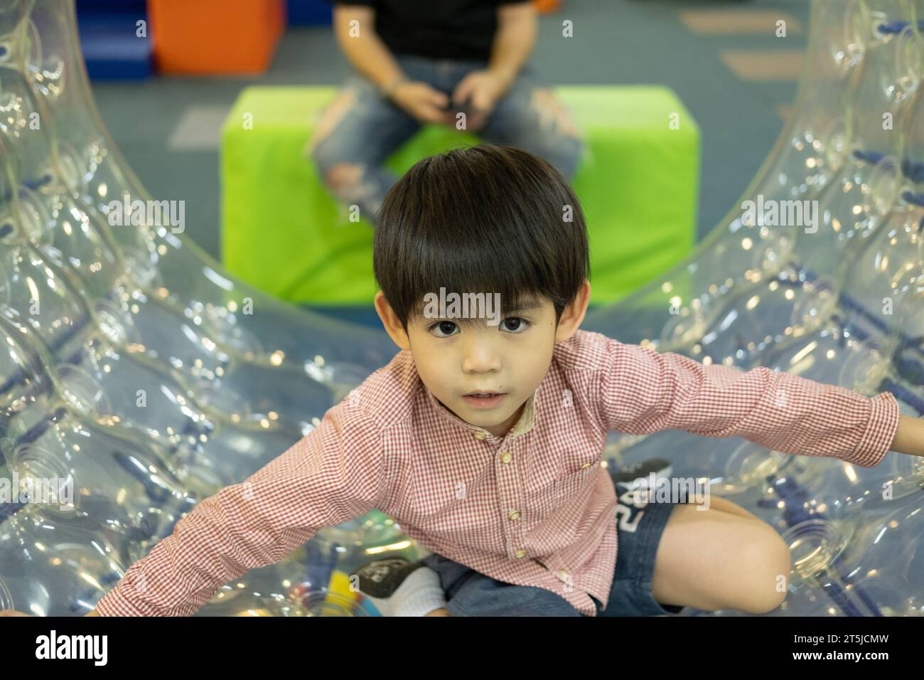 Child rolling giant ball hi-res stock photography and images - Alamy