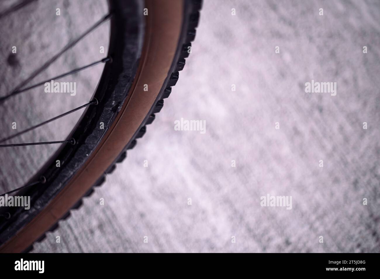 Tan wall mountain bike tyre on a black rim wheel Stock Photo - Alamy