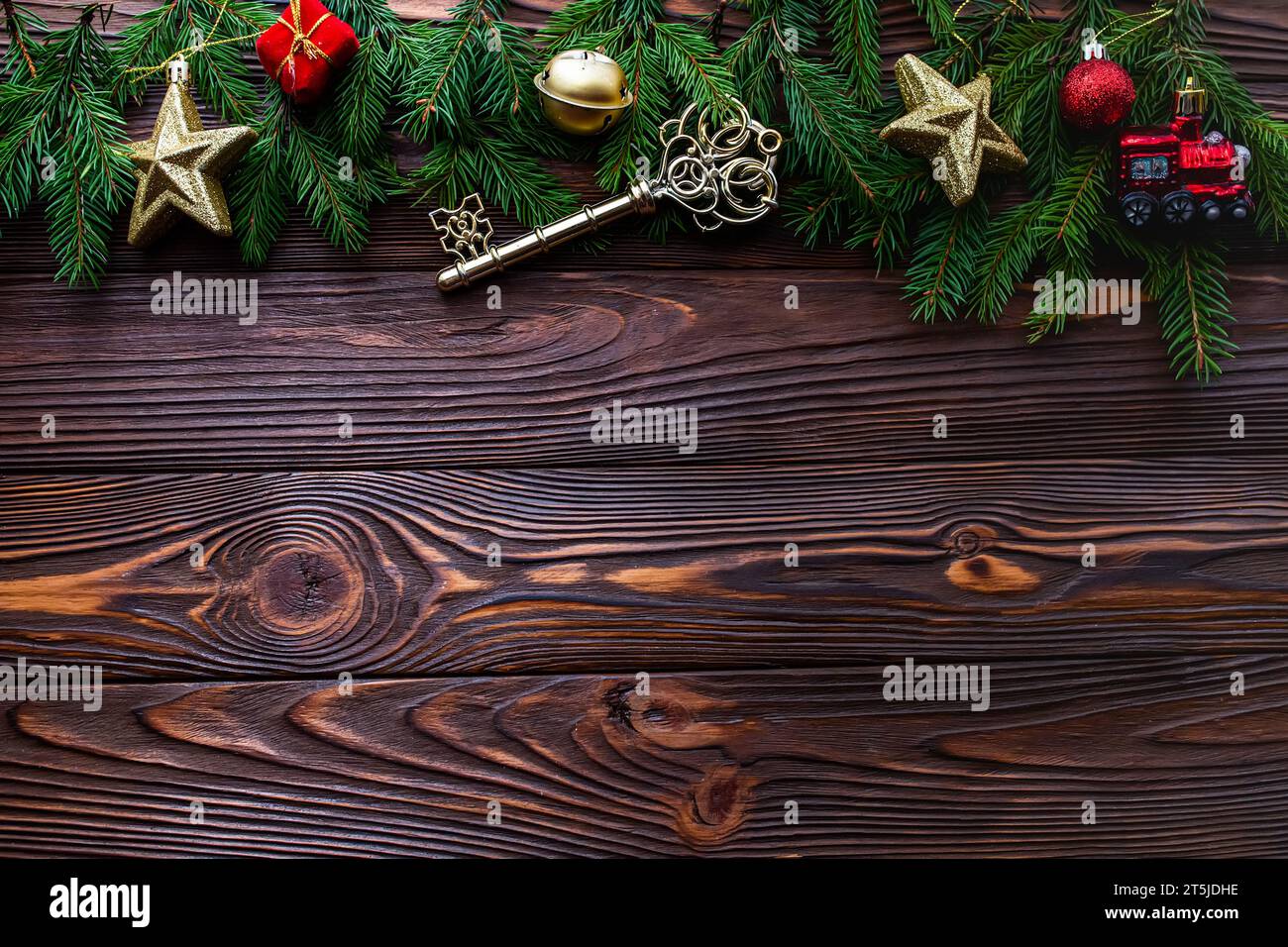Christmas background. A key to the doors of a new house on a wooden ...