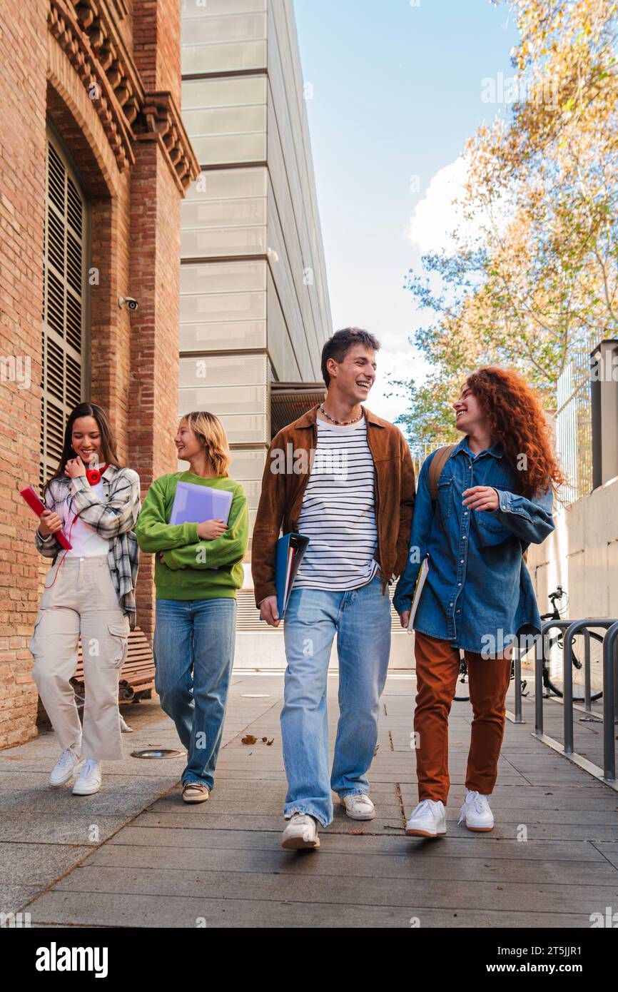 Vertical. Group of smiling high school teenage students walking before ...