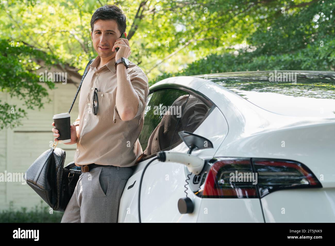 Eco friendly man and sustainable urban commute with EV electric car ...