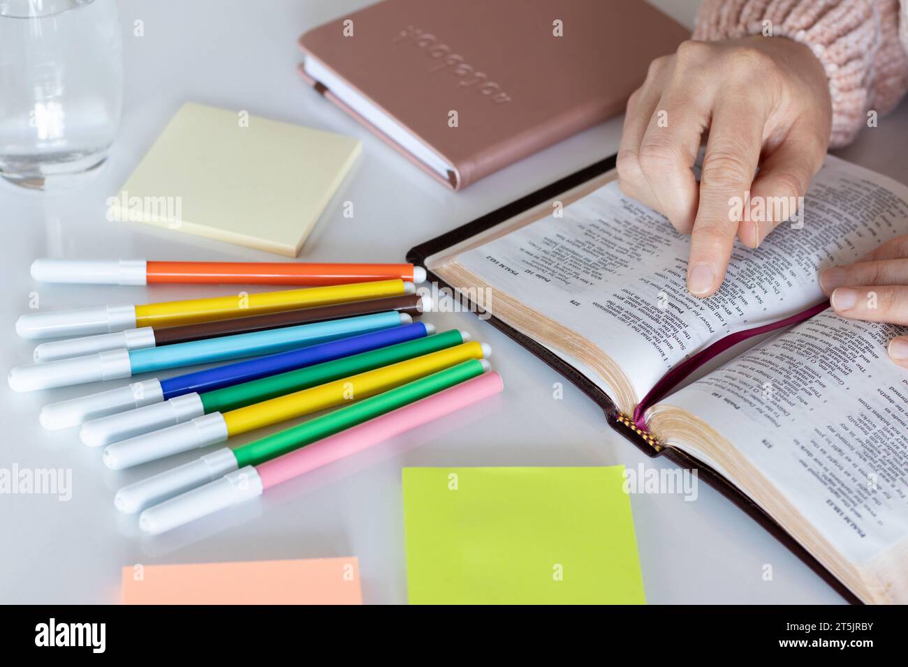 Hand holding open holy bible book and pointing to inspiring verse ...