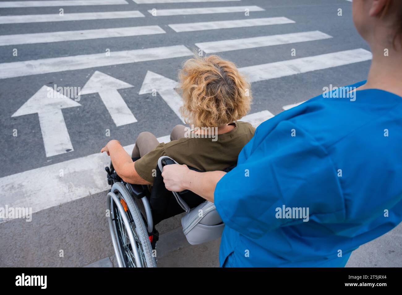 Helping elderly cross street hi-res stock photography and images - Alamy