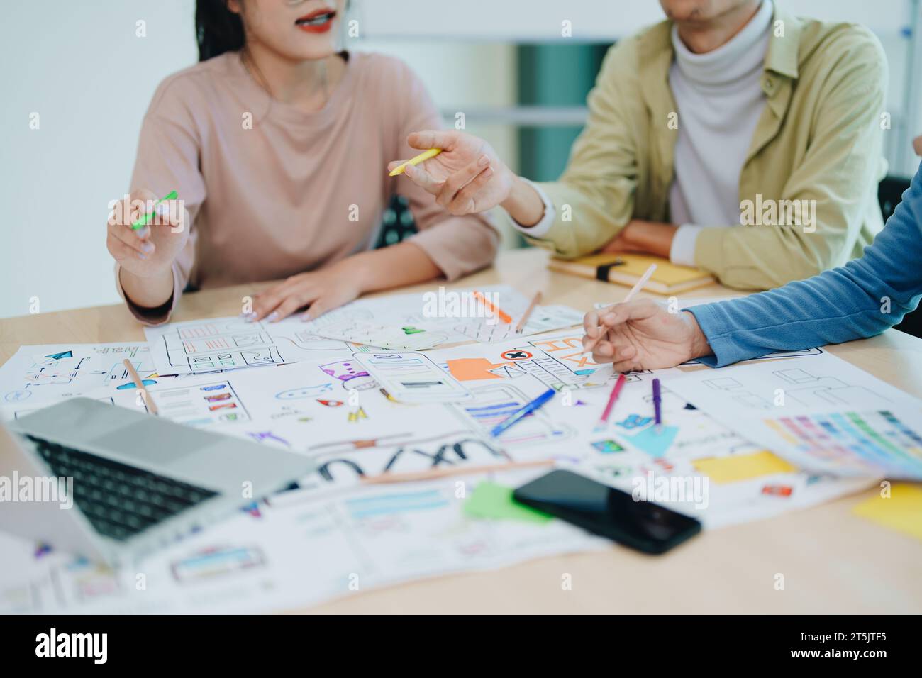 Group of asian creative team programing designers participate in all phases of the UX UI design ...