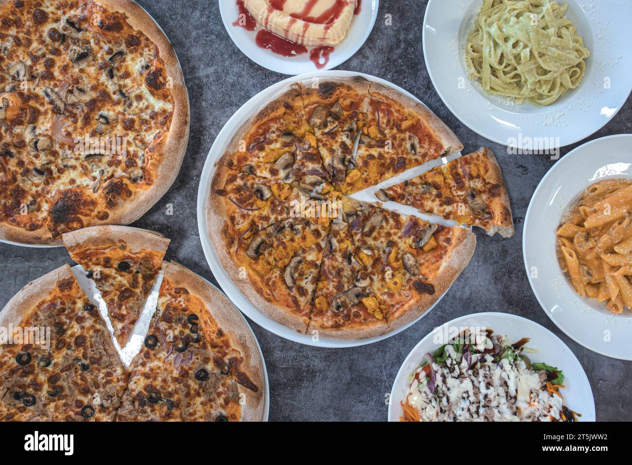 An arrangement of assorted plates with pizzas Stock Photo - Alamy