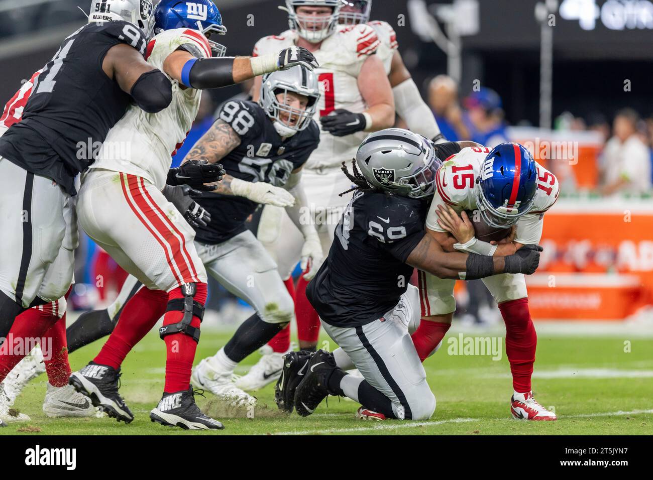 Las Vegas Raiders defensive tackle Adam Butler (69) sacks New York Giants quarterback Tommy ...