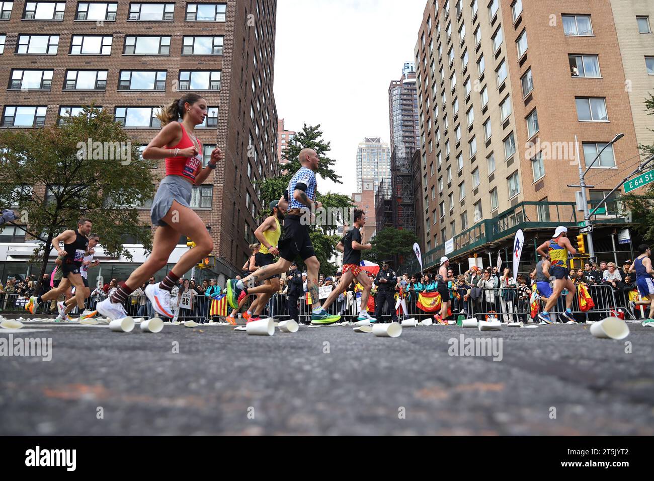 Runners step on used water cups discarded on the street during the 2023 ...