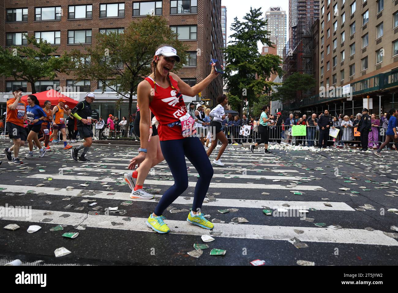 Runners step on used water cups discarded on the street during the 2023 ...
