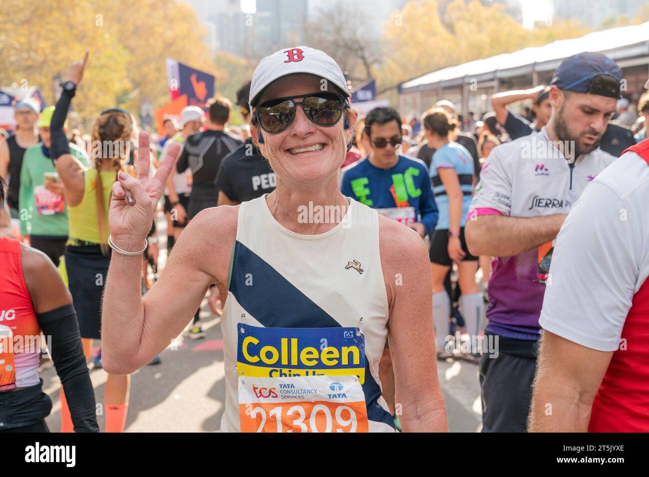 Runners pose after crossing finish line of TCS New York City marathon ...