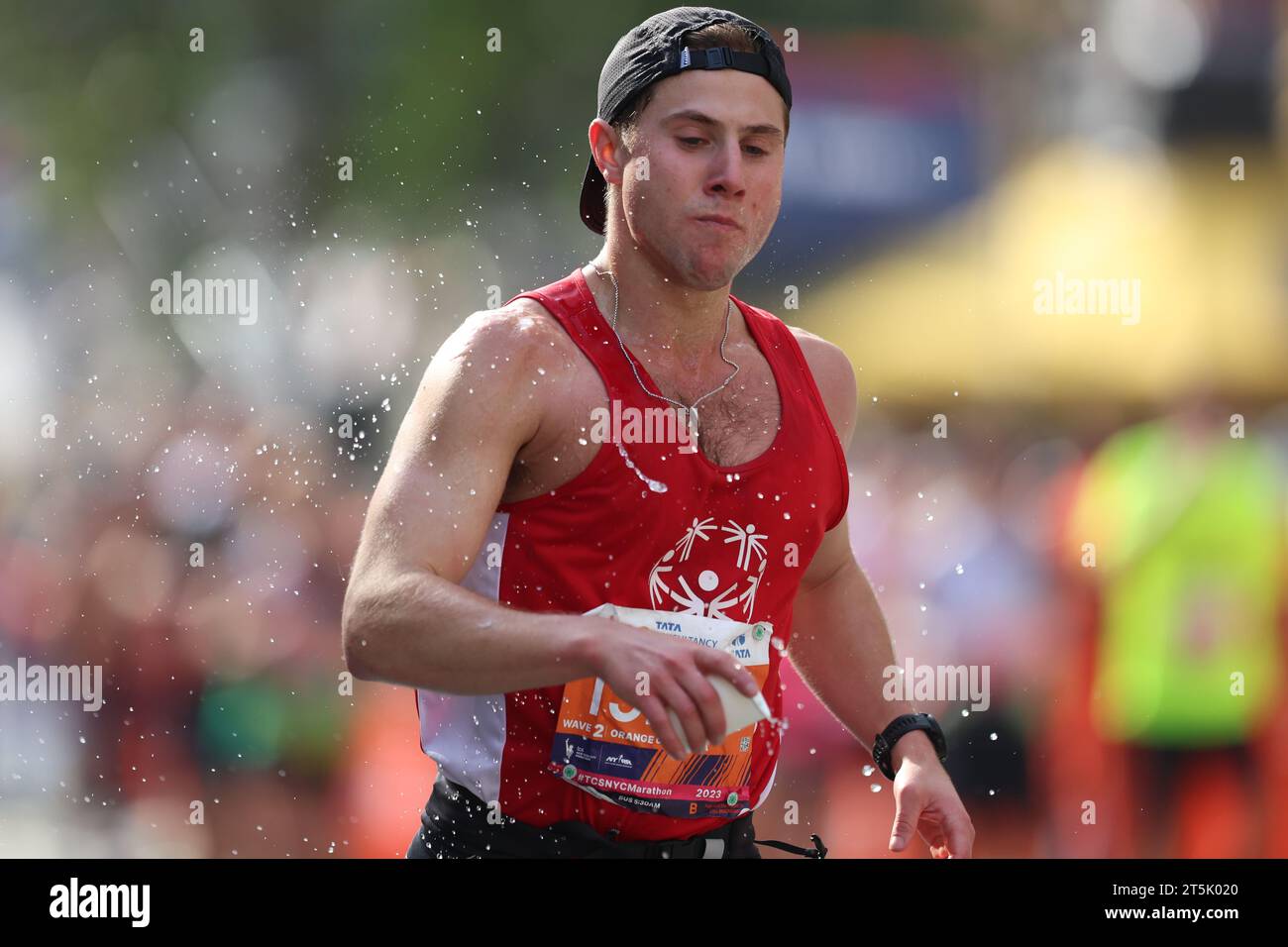 A runner gets some needed relief after dousing himself with water while ...