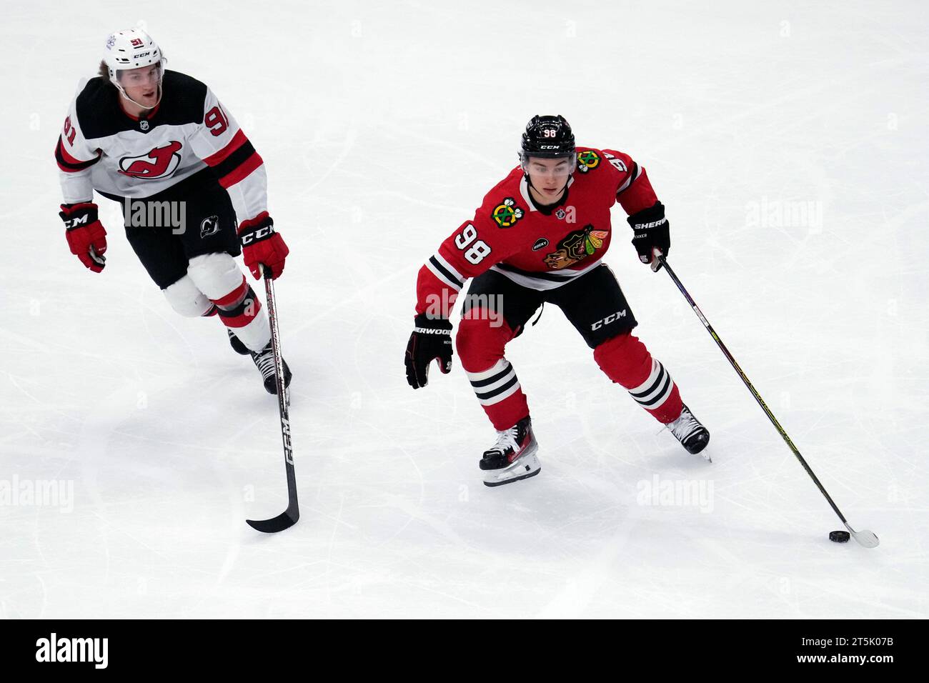 Chicago Blackhawks center Connor Bedard, right, controls the puck ...