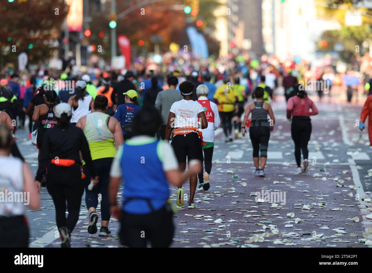 Runners step on used water cups discarded on First Avenue during the ...
